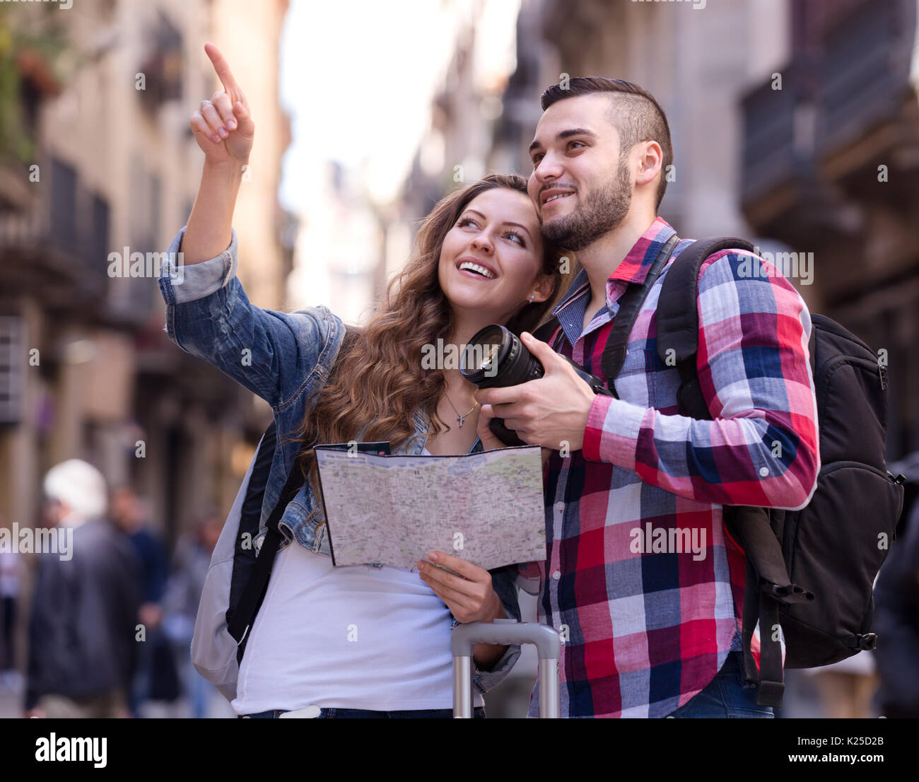 Happy tourists enjoying excursion over european town seeing sights and ...