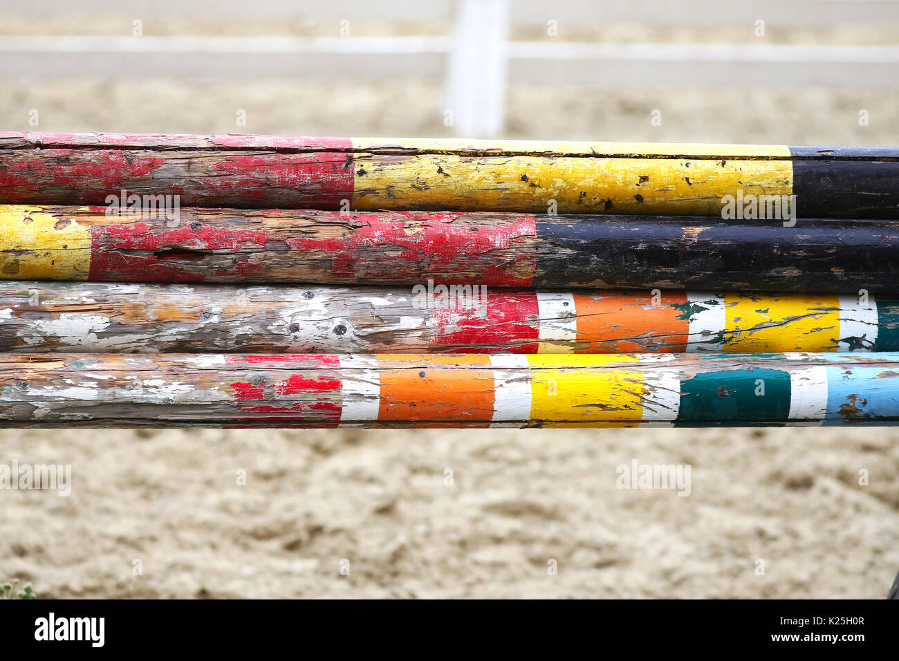 Colorful jump obstacles for equestrian sports outdoors against sandy ...