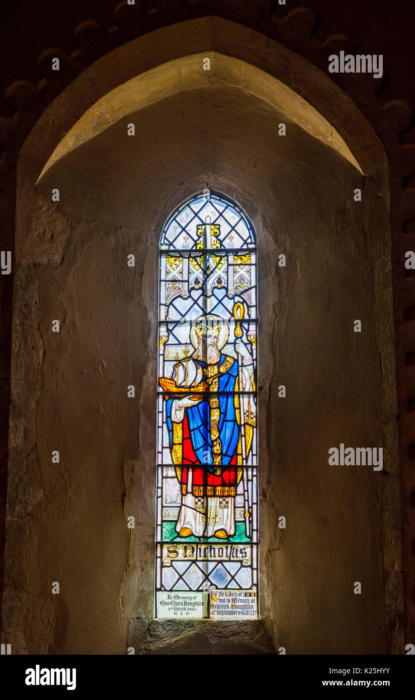 Stained glass window in St Nicholas church, an historic ancient church ...