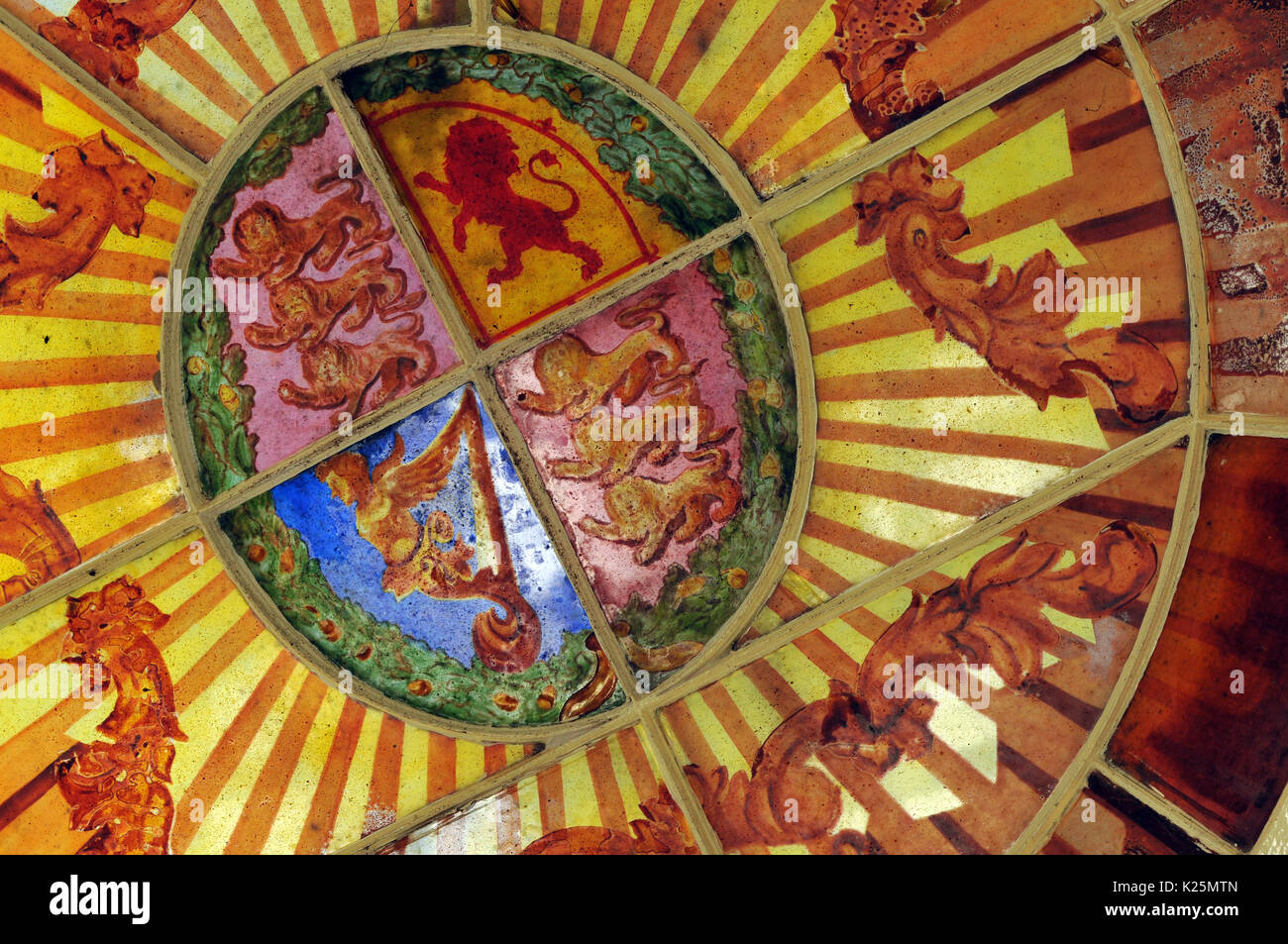 A beautiful heraldic crest design stained glass window n the roof off a ...