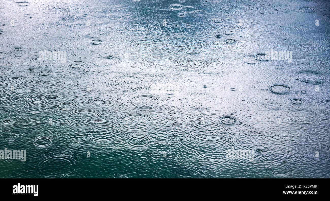 Abstract background, rain drops on the water Stock Photo - Alamy