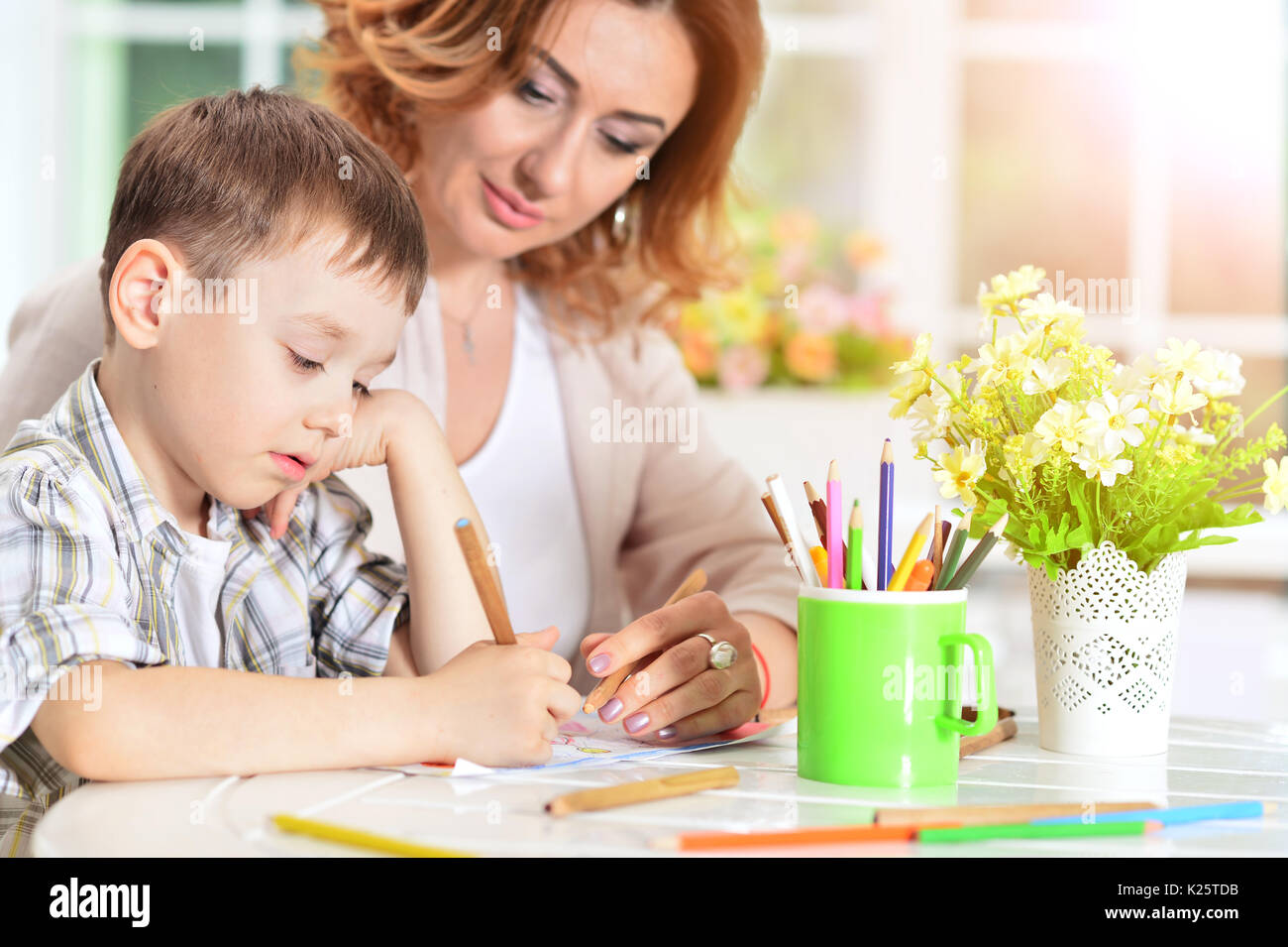 Portrait of cute little boy drawing with pencil Stock Photo - Alamy
