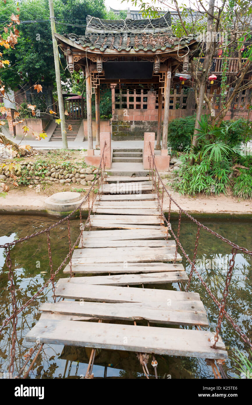 suspension bridge made with wood planks above a river in China Stock ...
