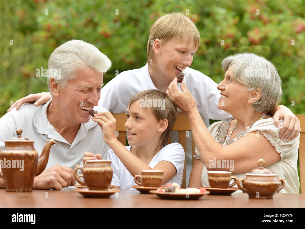 Portrait of a big happy family drinking tea outdoors Stock Photo - Alamy