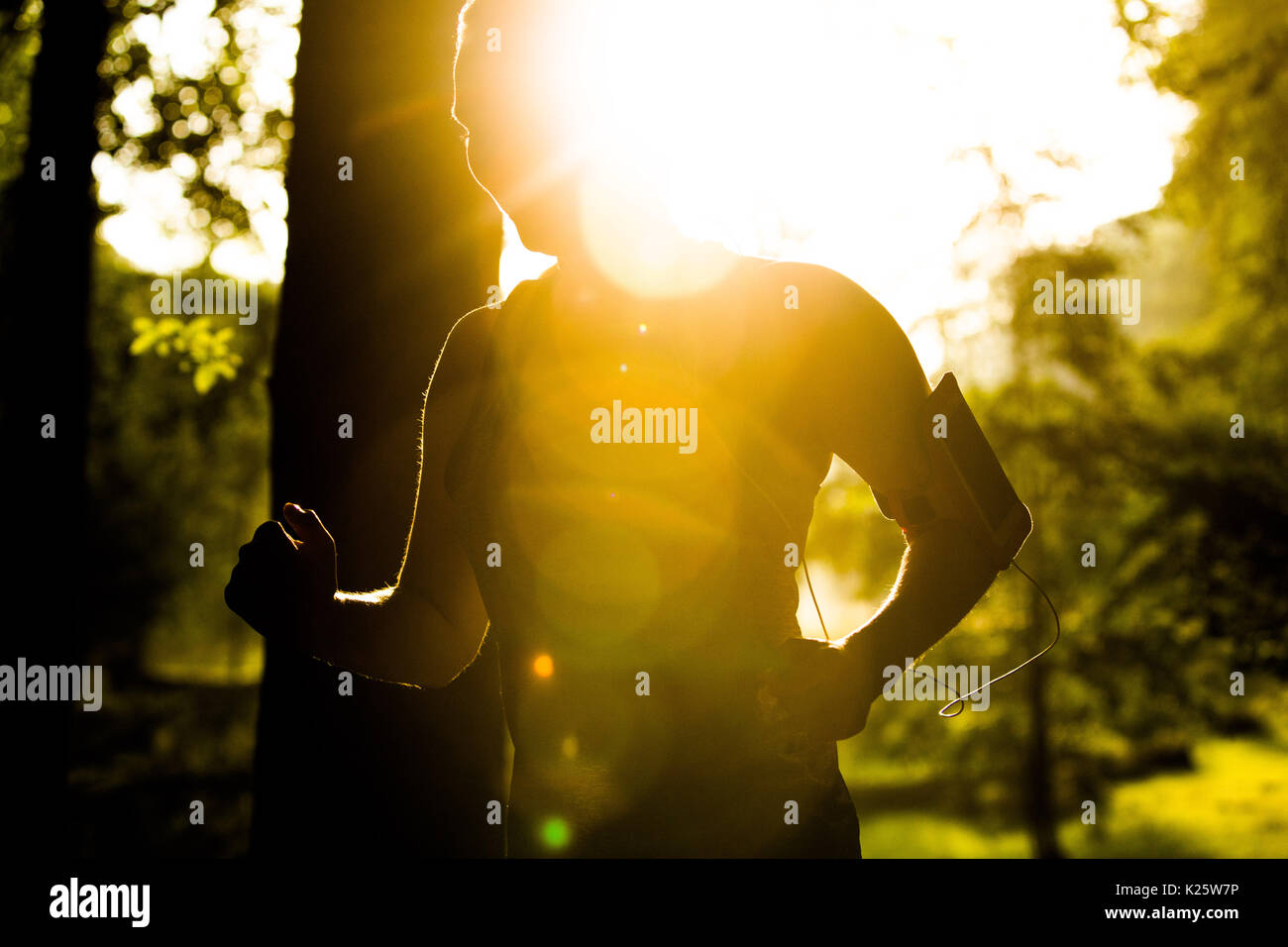 Beautiful fitness woman is running outdoors Stock Photo - Alamy