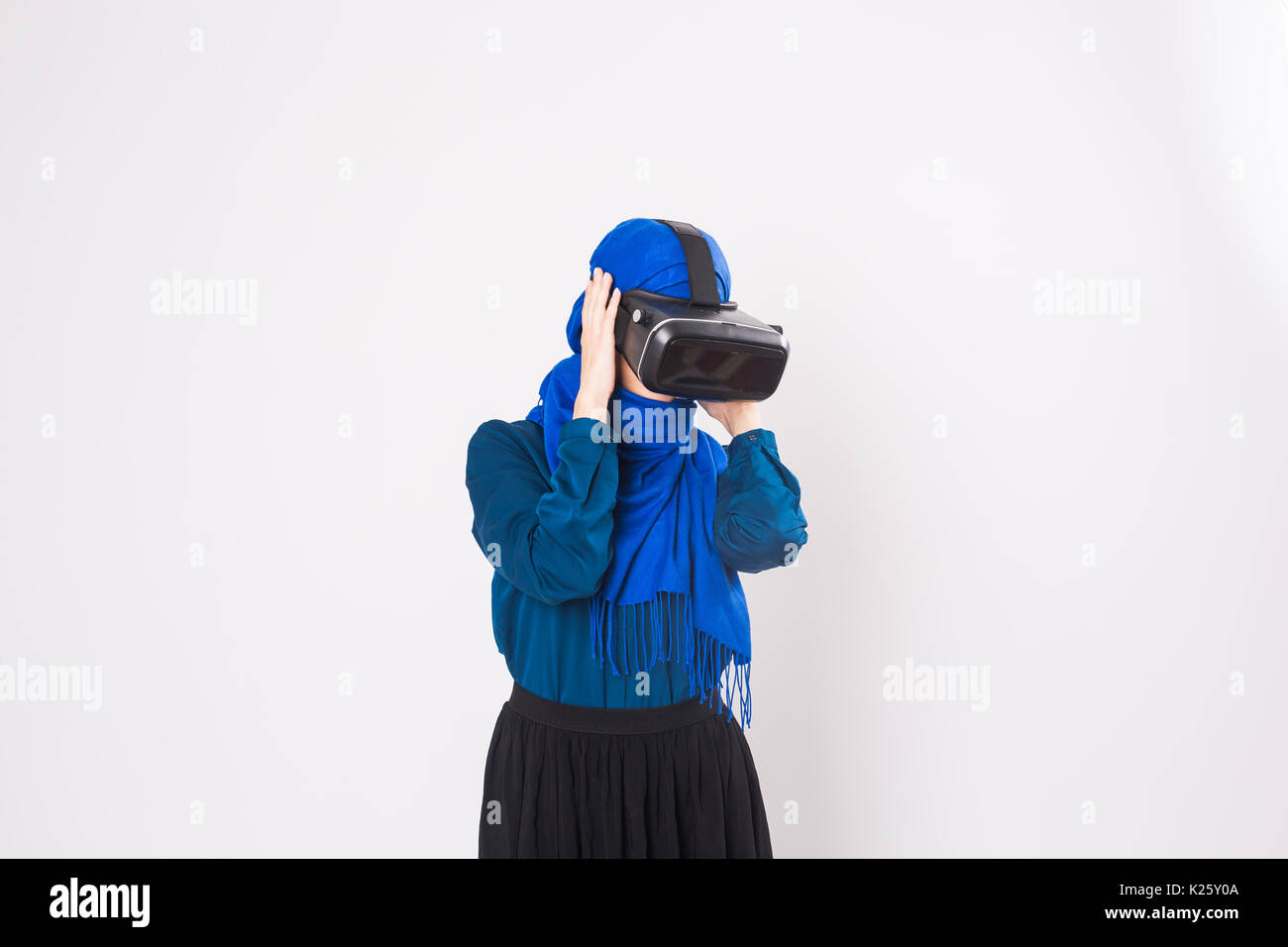 Asian muslim woman wearing hijab using VR headset glasses of virtual ...