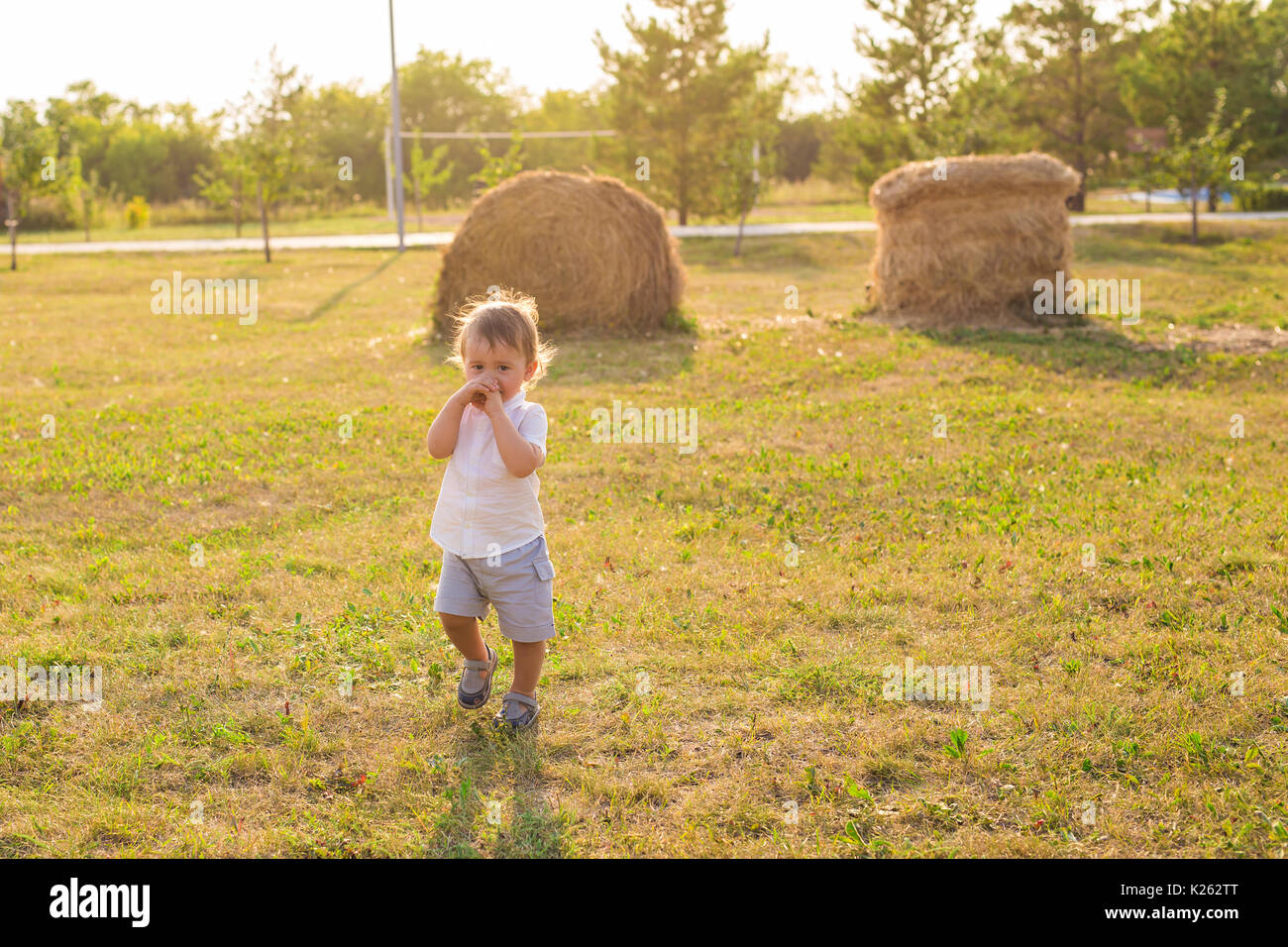 Portrait of cute little baby boy having fun outside. Smiling happy ...