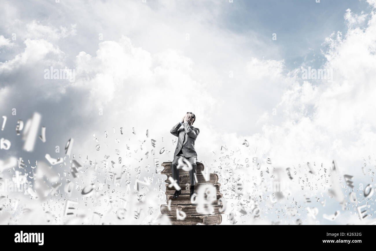 Young man floating in sky and do not want to see anything Stock Photo ...