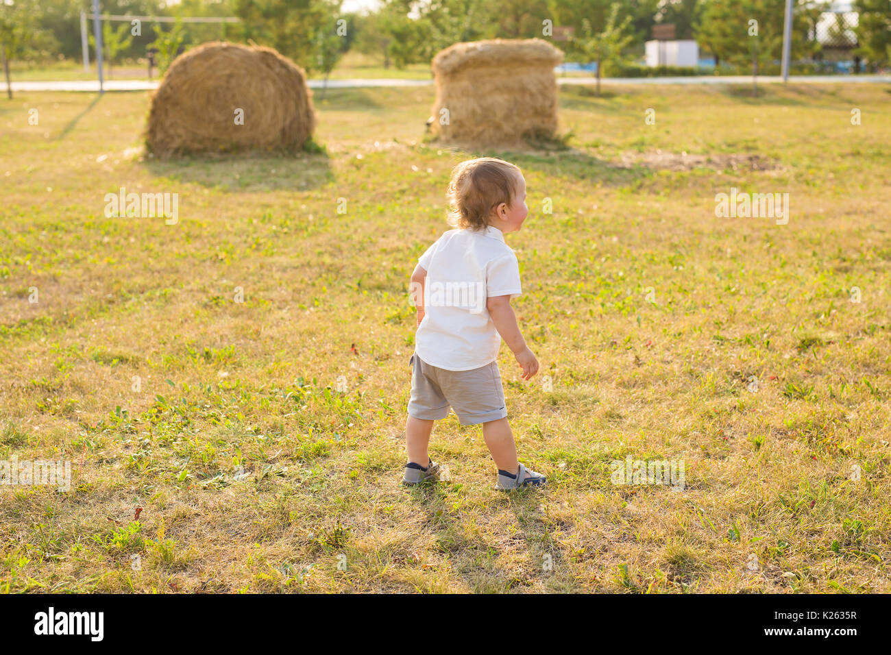 Portrait of cute little baby boy having fun outside. Smiling happy ...