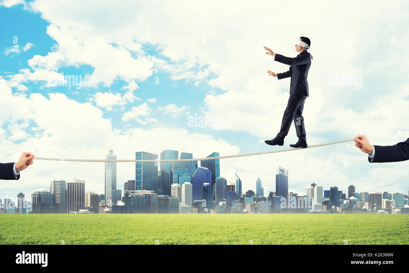 Businessman balancing on rope hi-res stock photography and images - Alamy