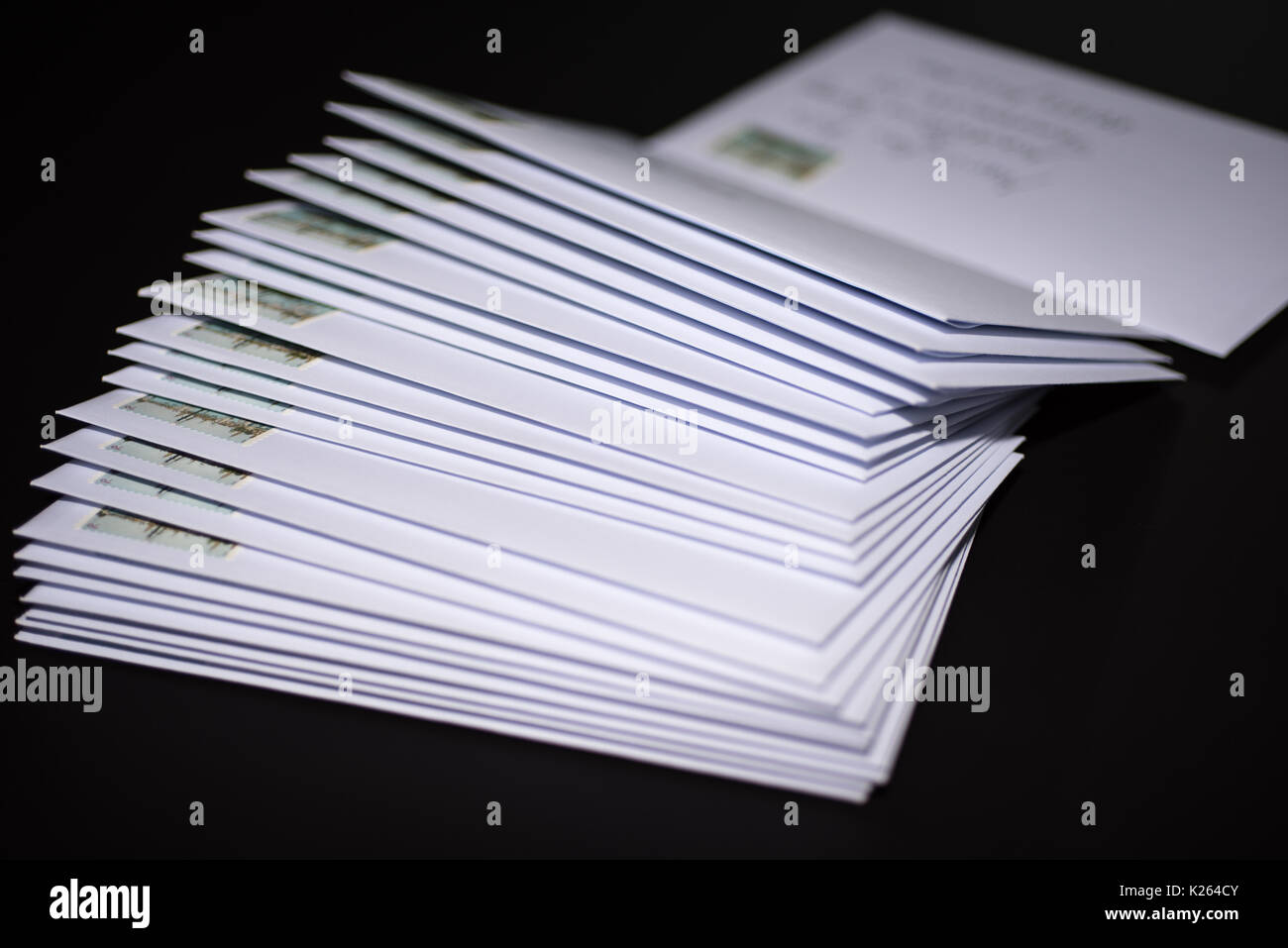 Stack of franked letters in white envelopes on black background Stock ...