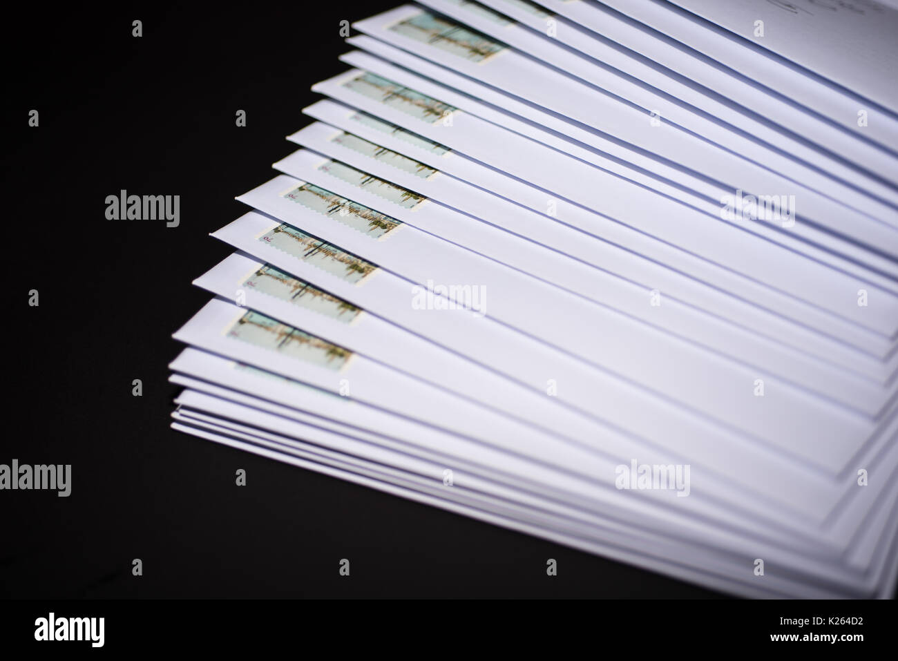 Stack of franked letters in white envelopes on black background Stock ...