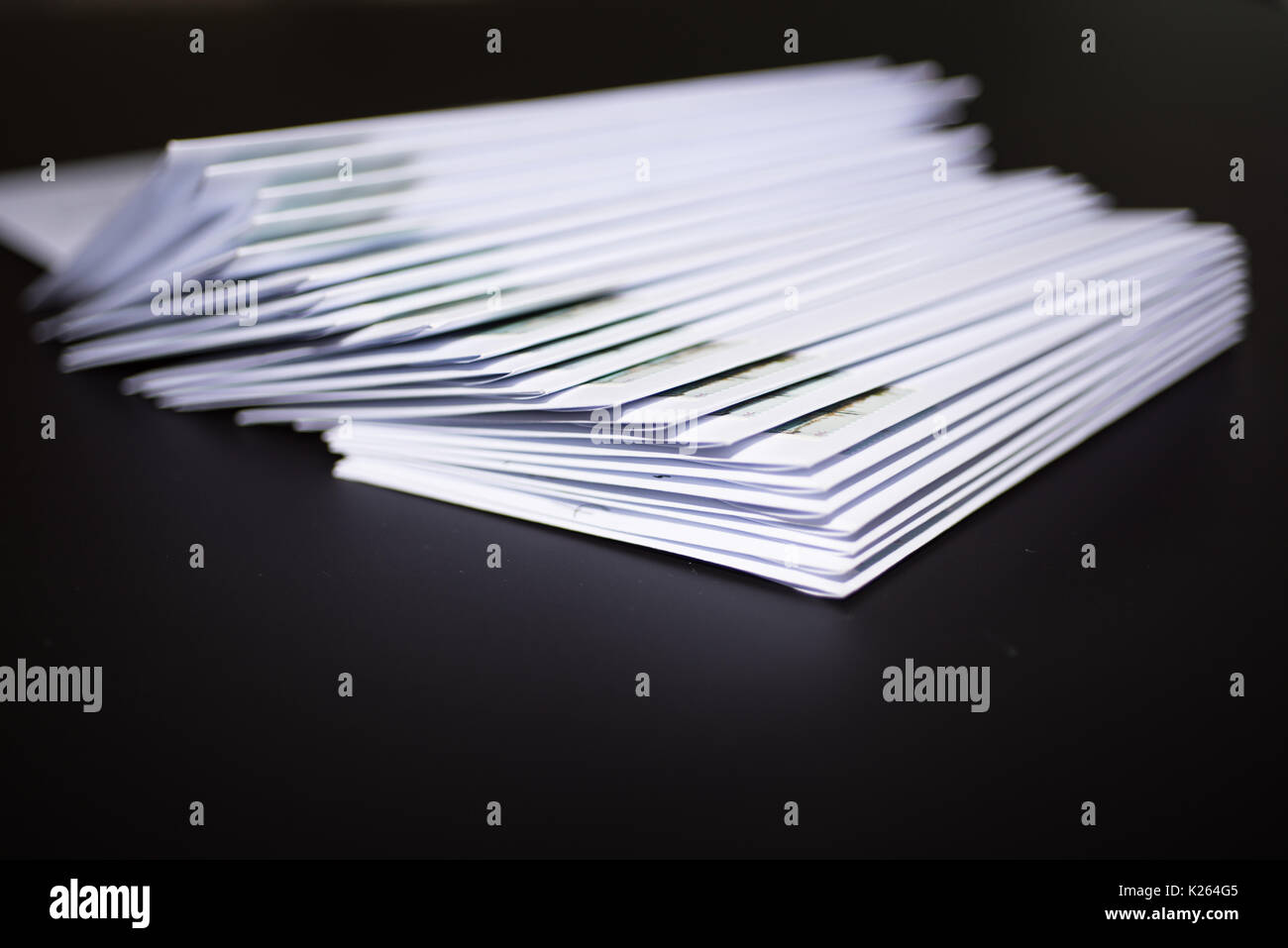 Stack of franked letters in white envelopes on black background Stock ...