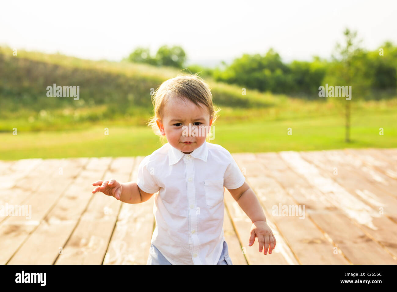 Portrait of cute little baby boy having fun outside. Smiling happy ...