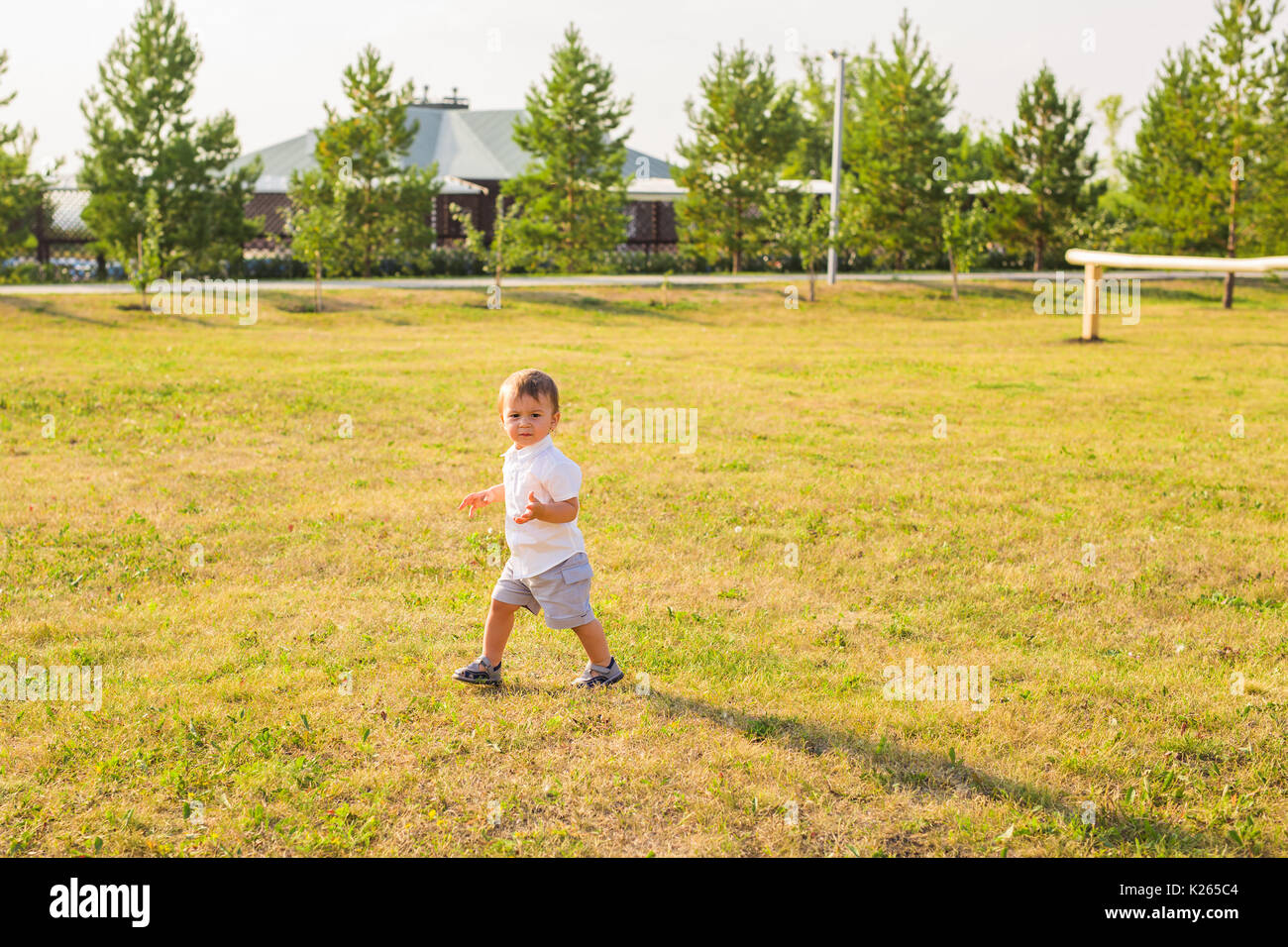 Happy laughing baby boy running on summer or autumn field Stock Photo ...