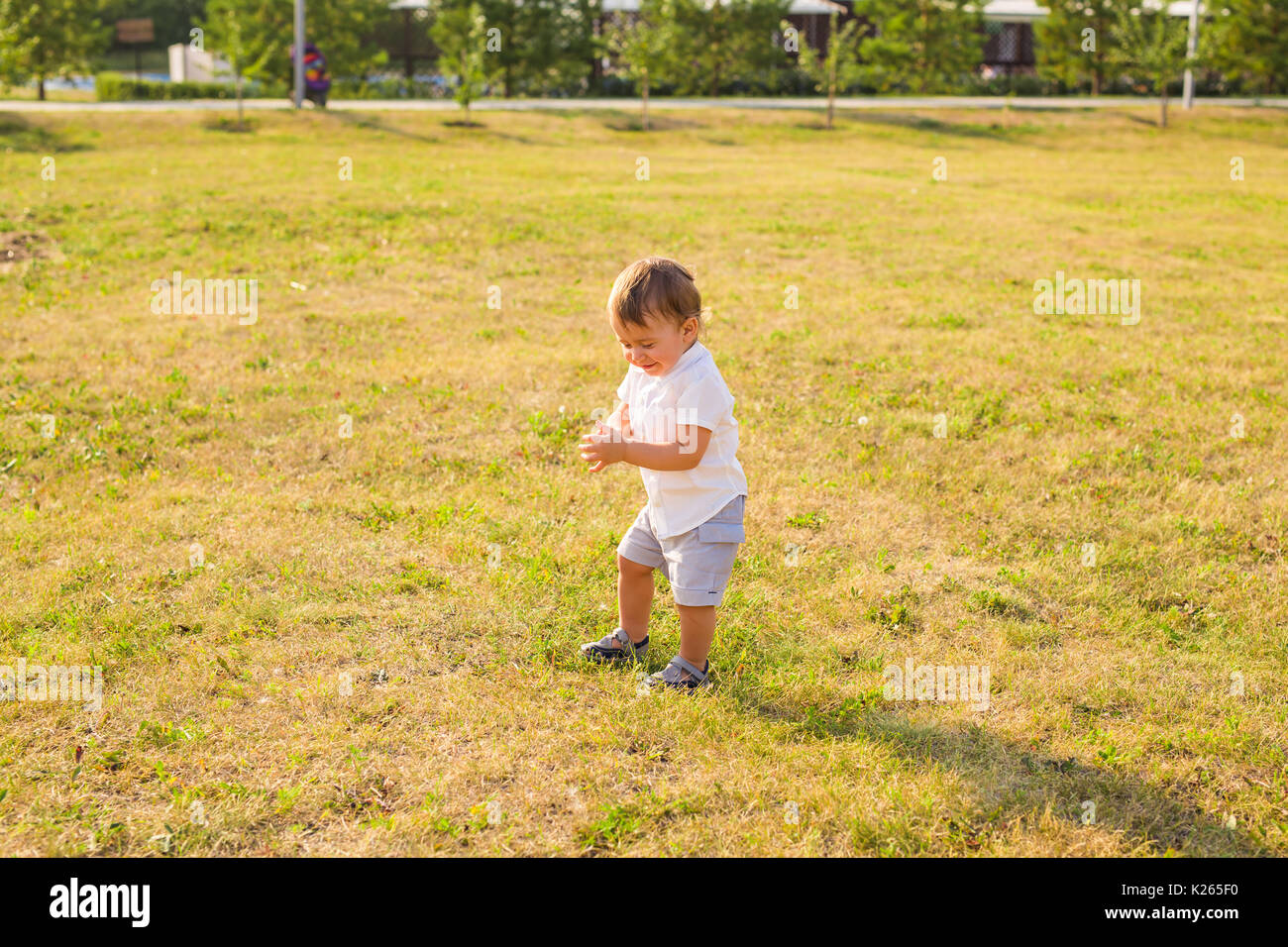 Happy laughing baby boy running on summer or autumn field Stock Photo ...