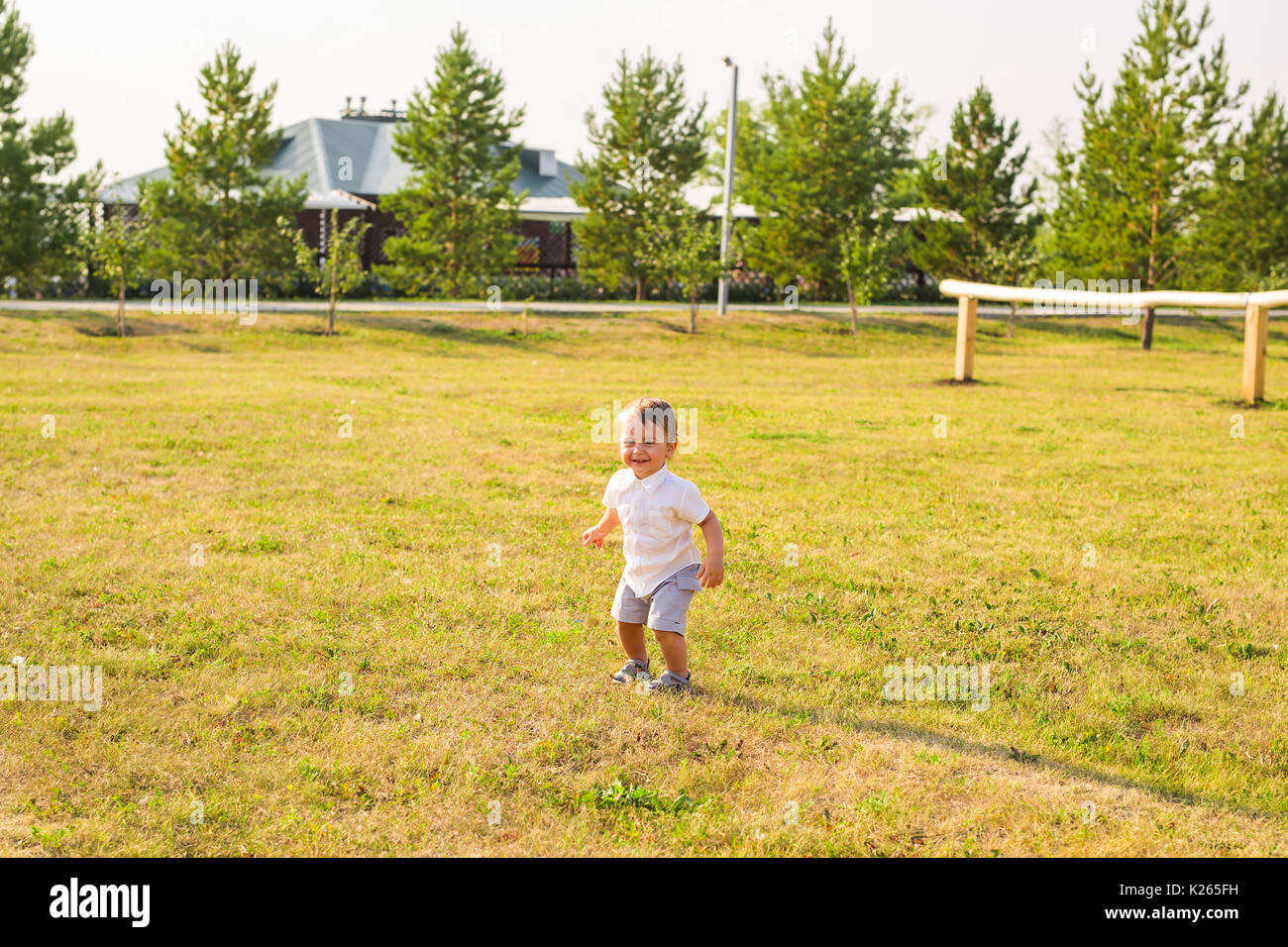 Portrait of cute little baby boy having fun outside. Smiling happy ...