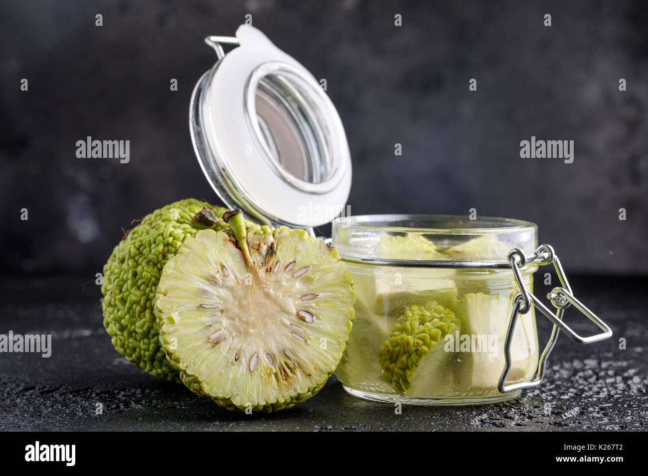 Adam's apple on a black background. Tincture of Adam's apple in a glass ...