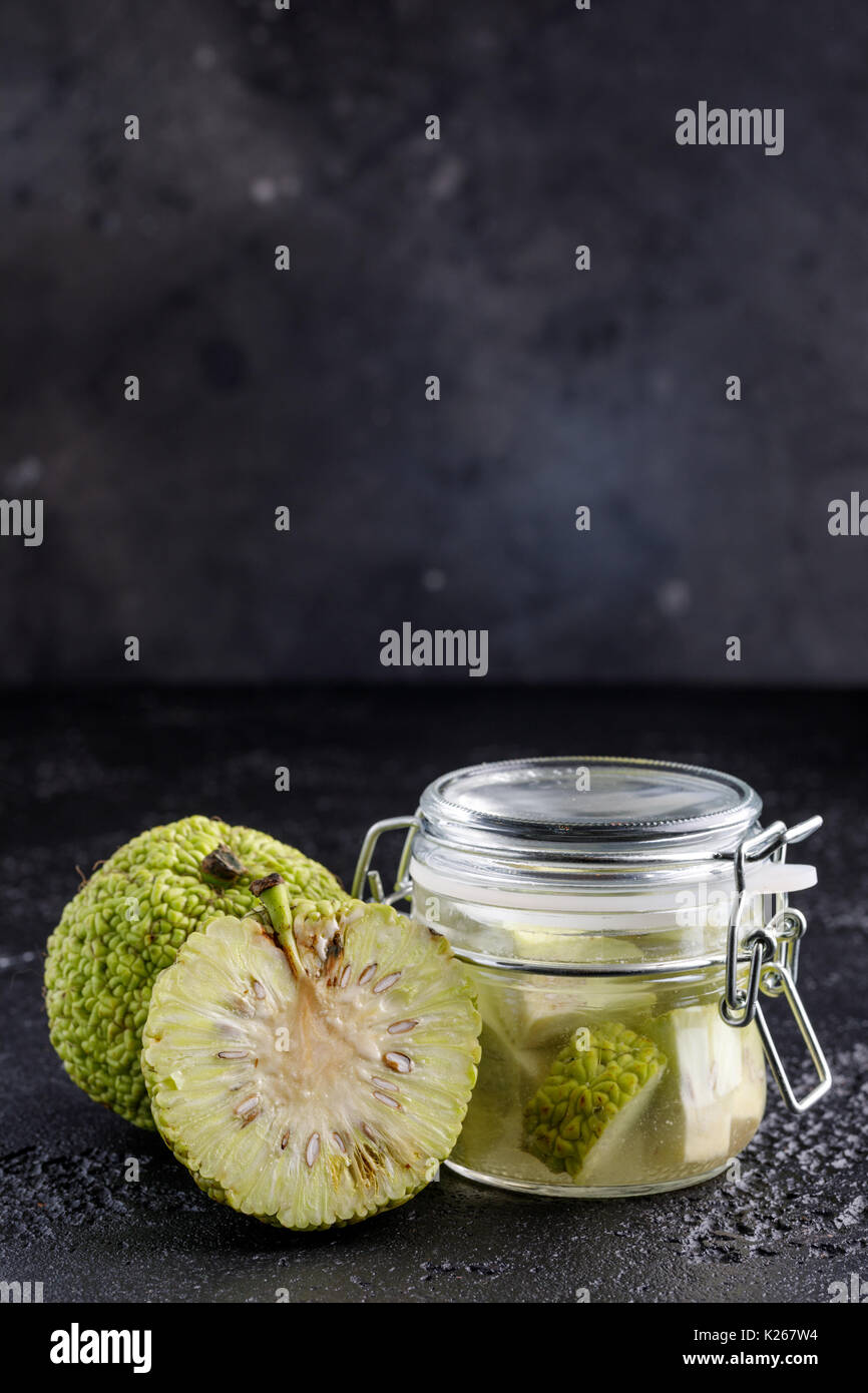 Adam's apple on a black background. Tincture of Adam's apple in a glass ...