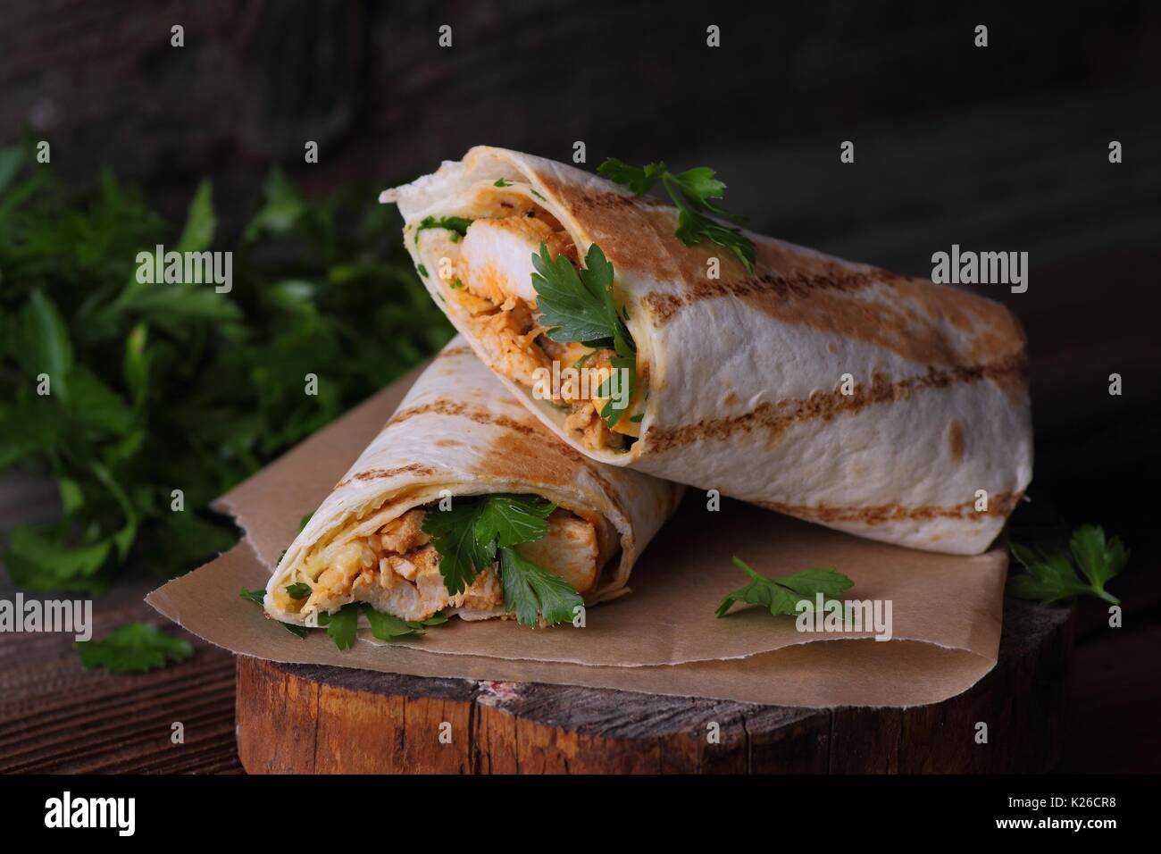 Tasty wraps with grilled chicken meat and fresh parsley Stock Photo - Alamy
