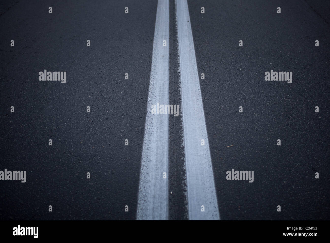 Asphalt road with marking lines white stripes. Two solid lines ...