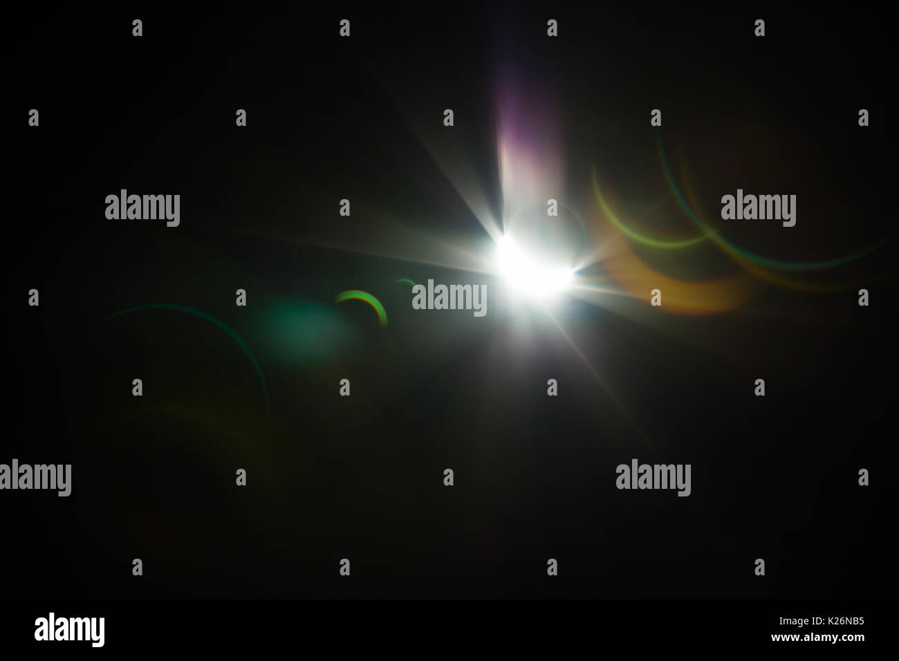 Solar eclipse with colourful lens flares, taken minutes before totality ...