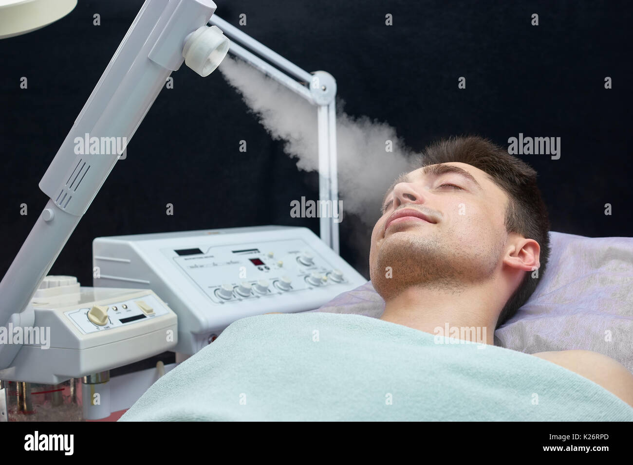 Face steaming, young man. Caucasian guy in beauty clinic. Facial ...