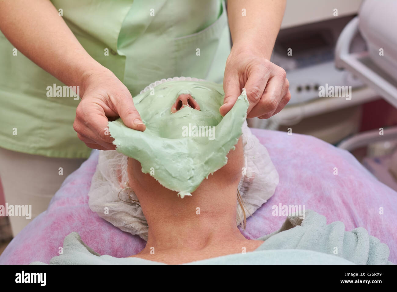 Cosmetician removing facial mask. Woman in a cosmetology clinic Stock ...