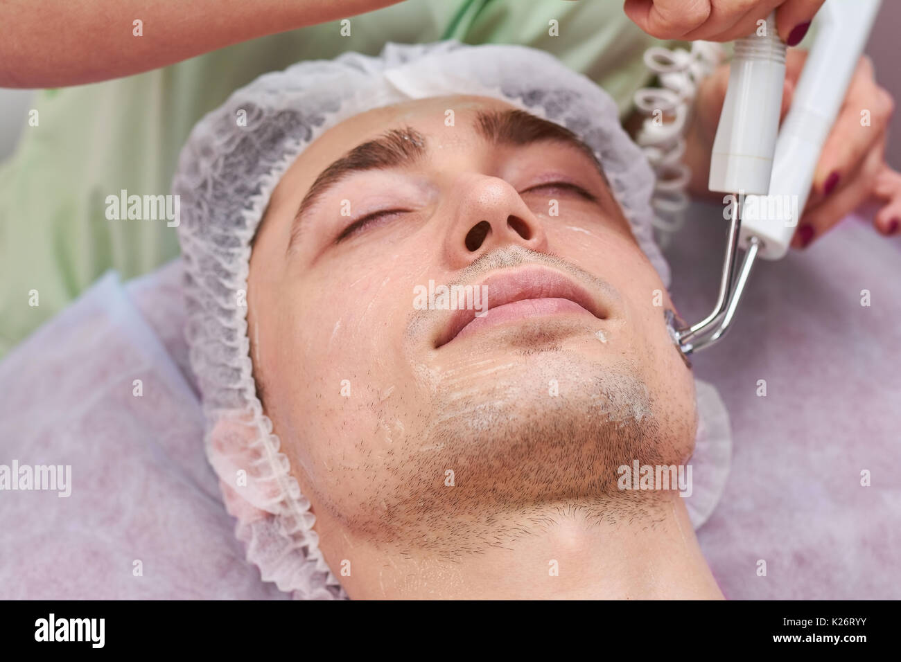 Close up of microcurrent treatment. Male face, cosmetology procedure ...