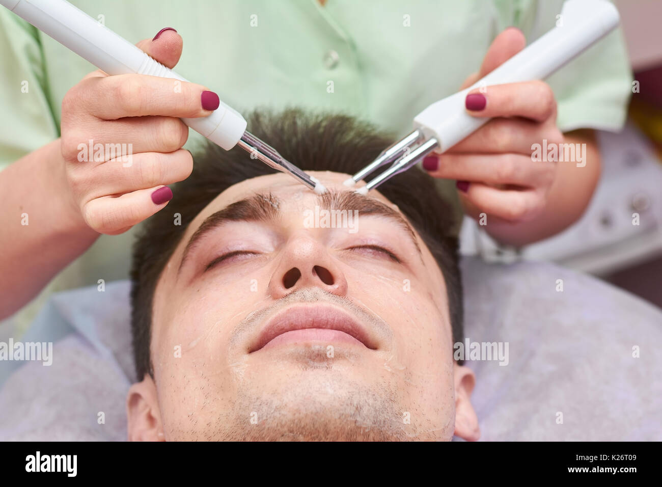 Microcurrent therapy device, male face. Caucasian man, cosmetology ...