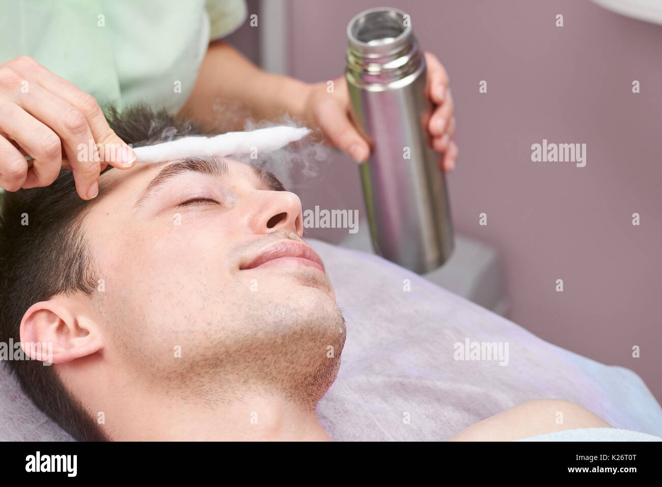 Face cryomassage, caucasian man. Skin cryotherapy close up. Liquid ...