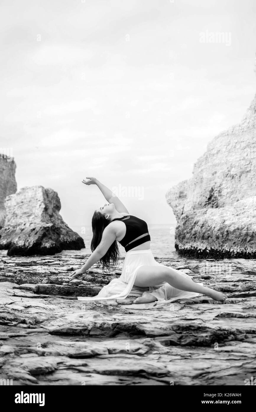 Dancer posing on rocks Stock Photo - Alamy