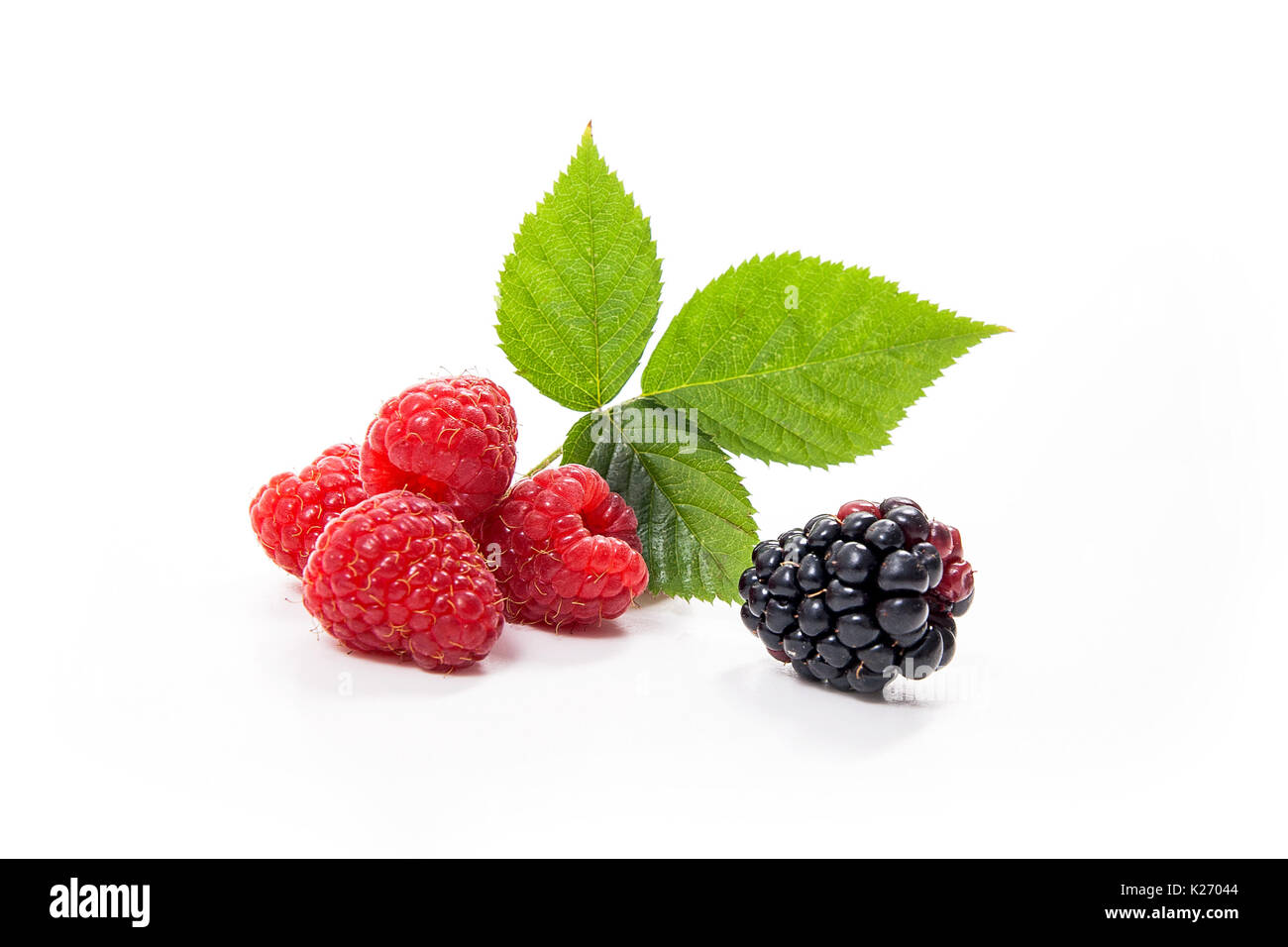Close up view of fresh raspberries fruits with green leaf of raspberry ...