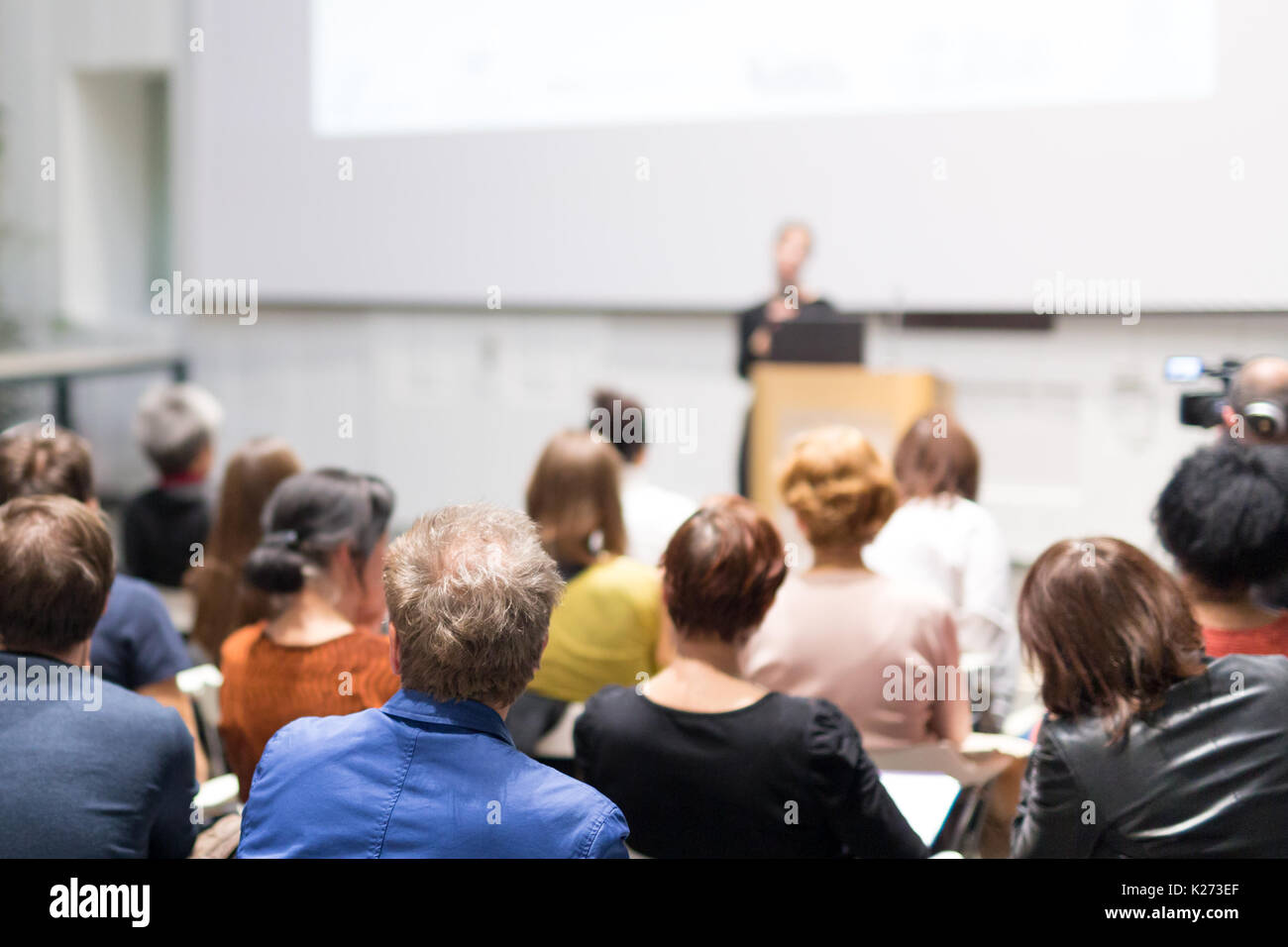Woman giving presentation on business conference Stock Photo - Alamy