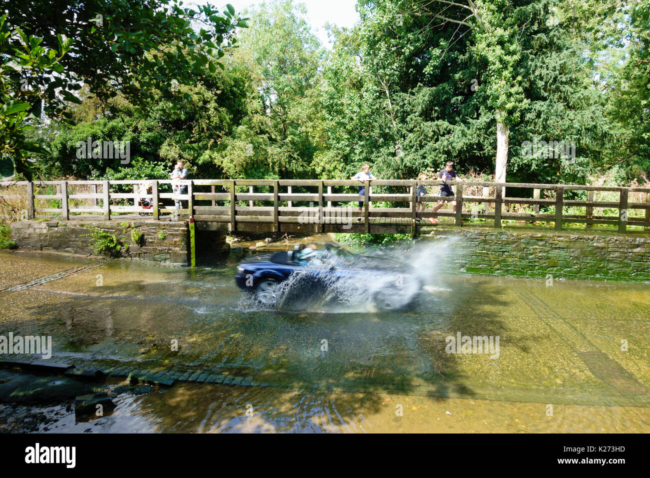 Car driving at speed through the ford at Rufford, Nottinghamshire Stock ...