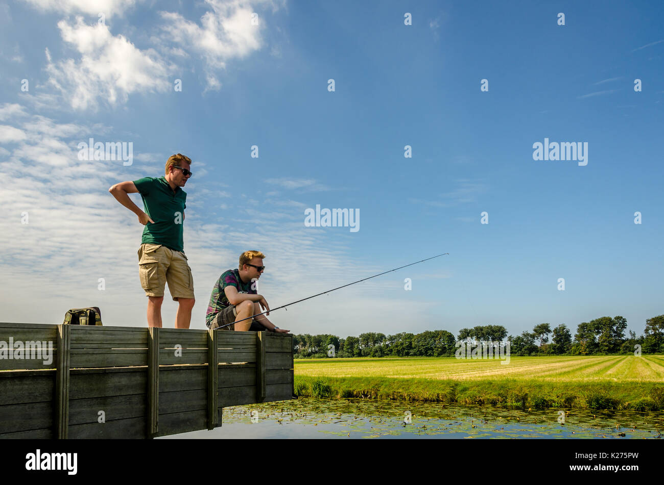 2 fisherman waiting for the fish to catch Stock Photo - Alamy