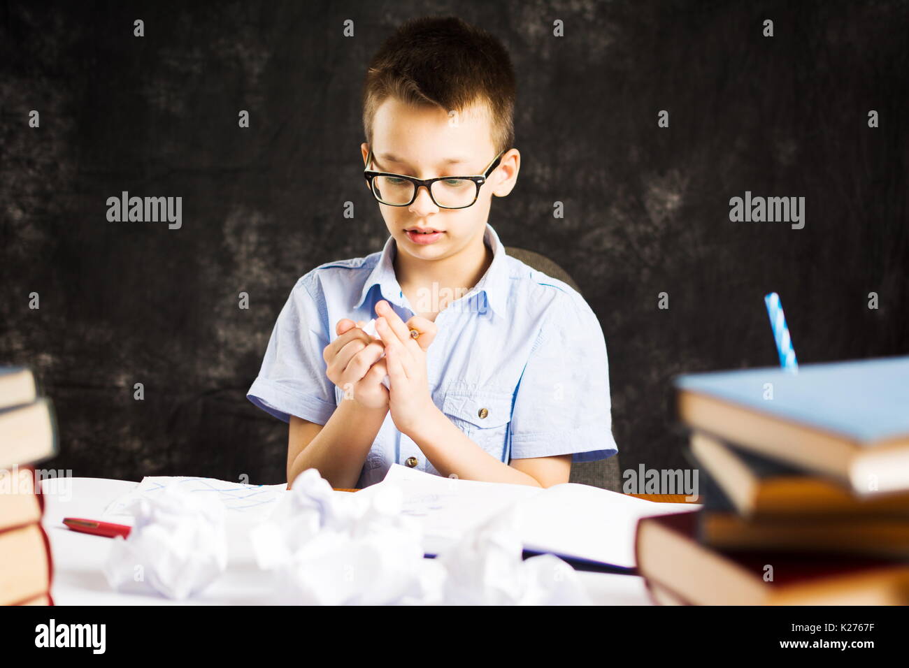 Boy throws away paper with homework failure Stock Photo - Alamy