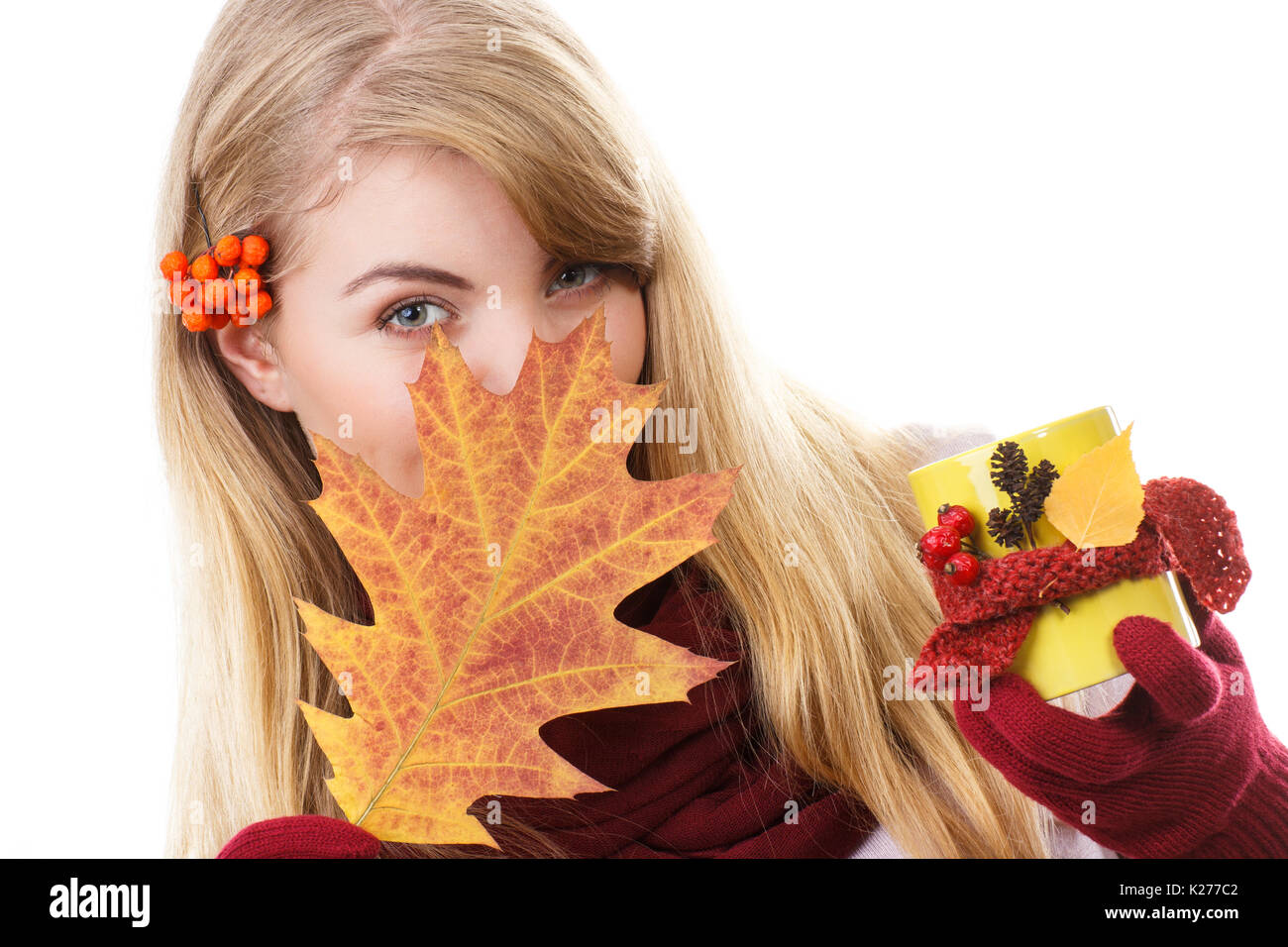 Girl with rowan in hair wearing woolen shawl and gloves, holding ...