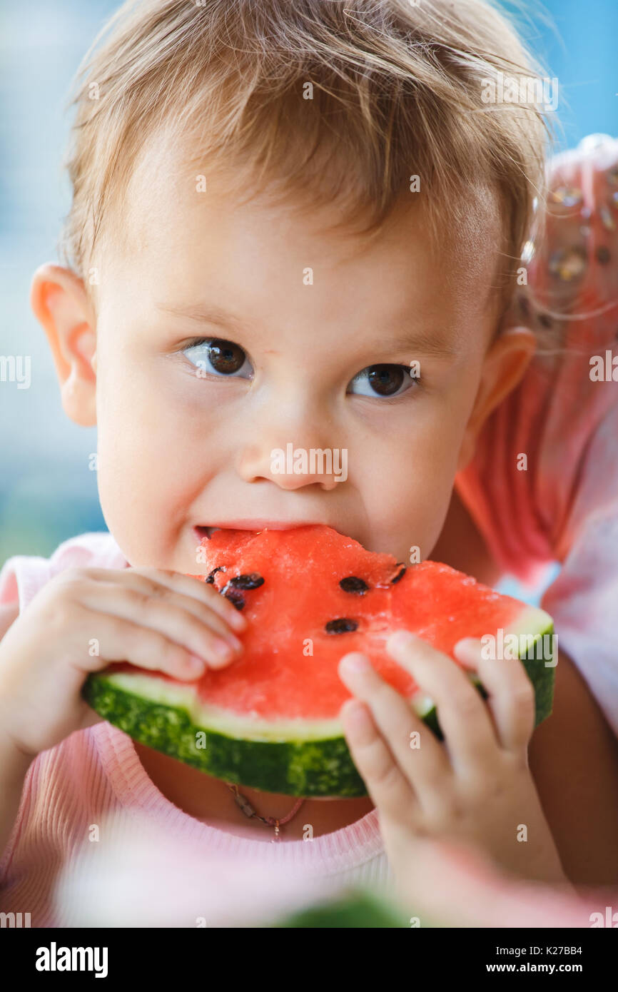Child eating watermelon Stock Photo - Alamy