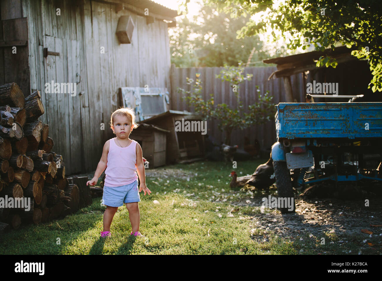 Child playing in backyard Stock Photo - Alamy