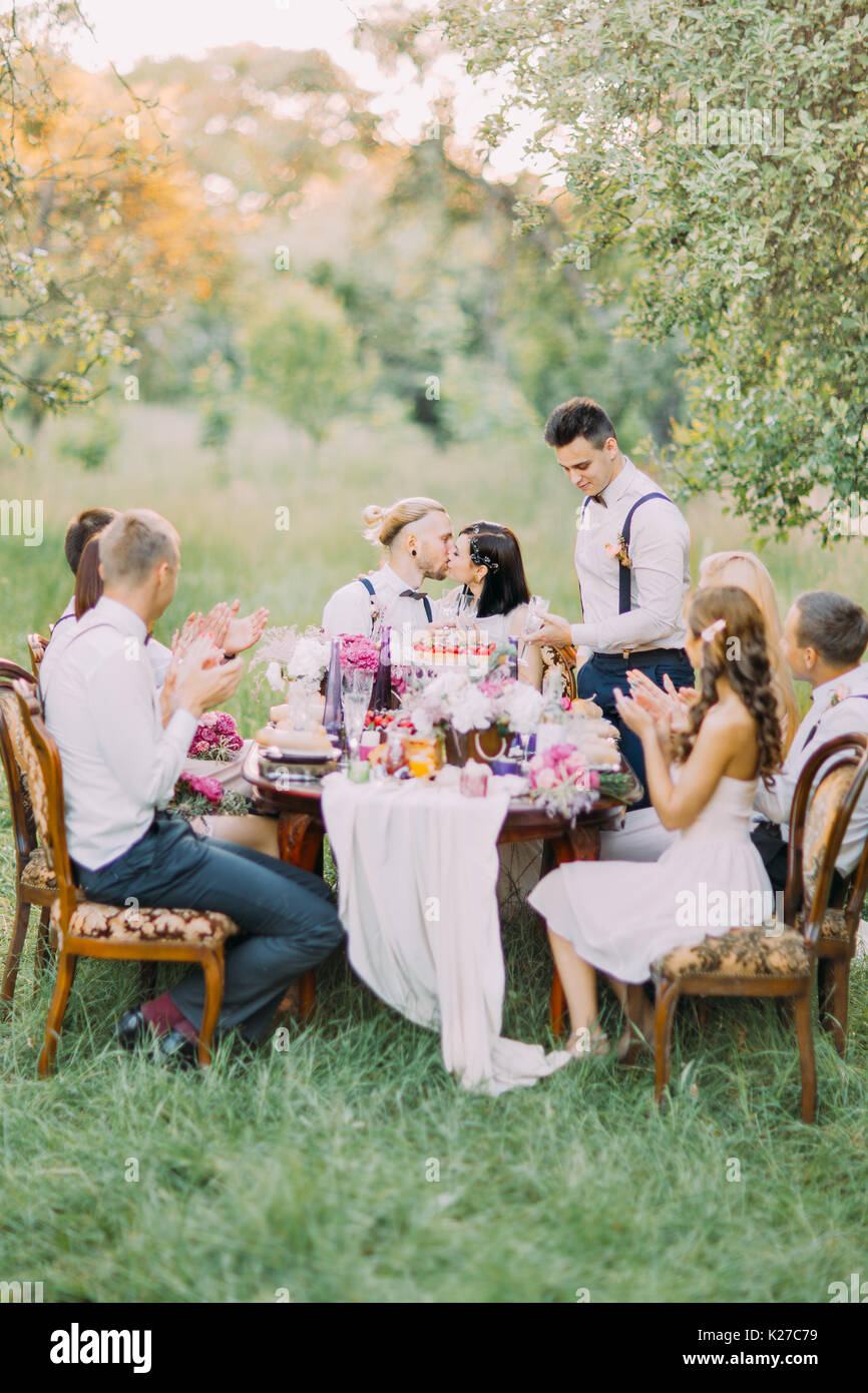 The vertical photo of the wedding dinner in the sunny wood. The ...