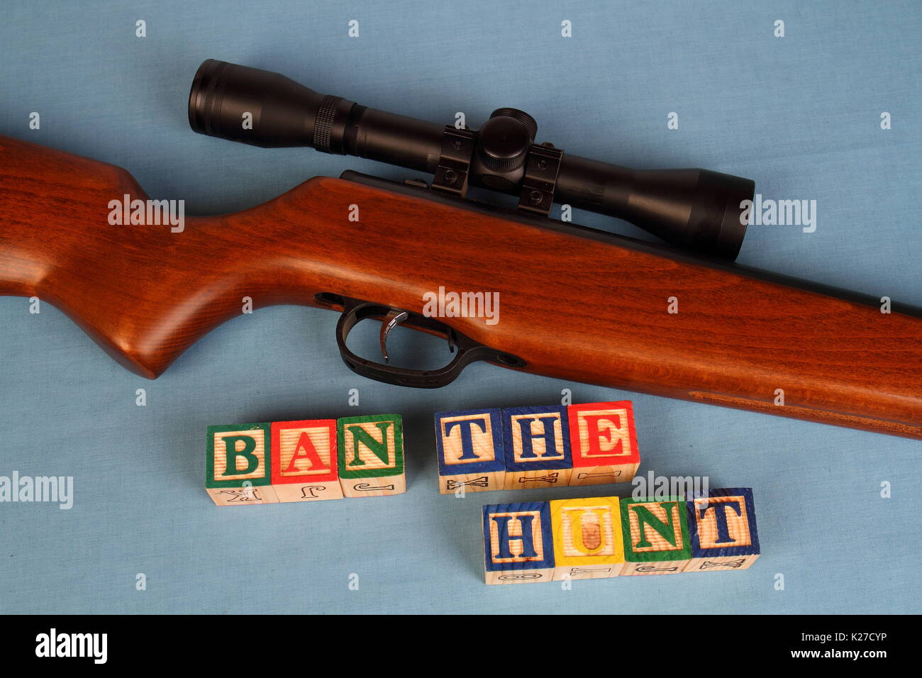 Hunting rifle with a telescope mounted together with the phrase Ban the ...