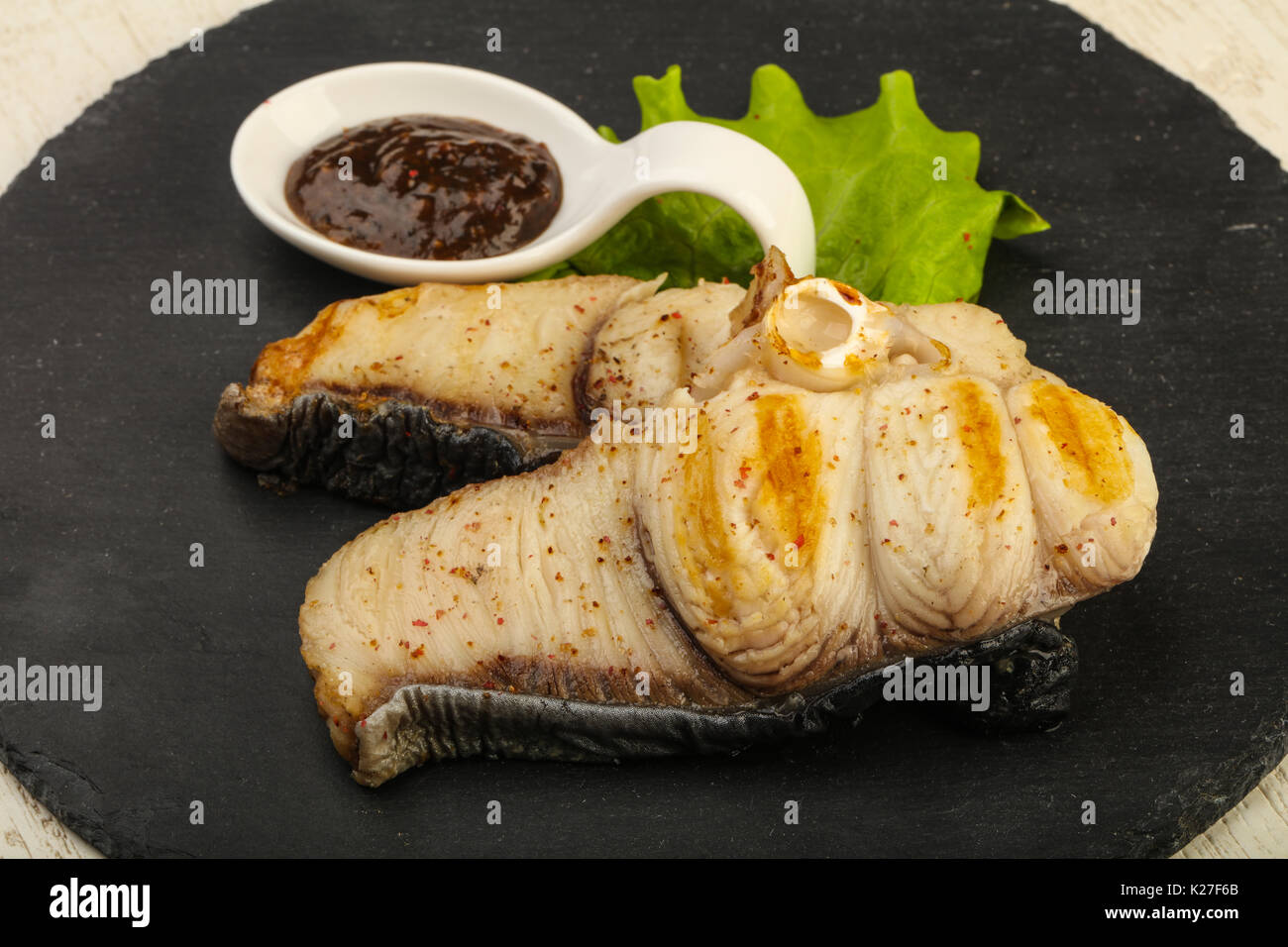 Grilled shark steak with pepper sauce and salad leaves Stock Photo - Alamy