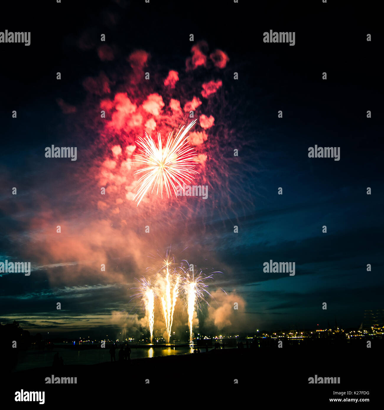 Beautiful, colorful fireworks above the river during an Independence ...