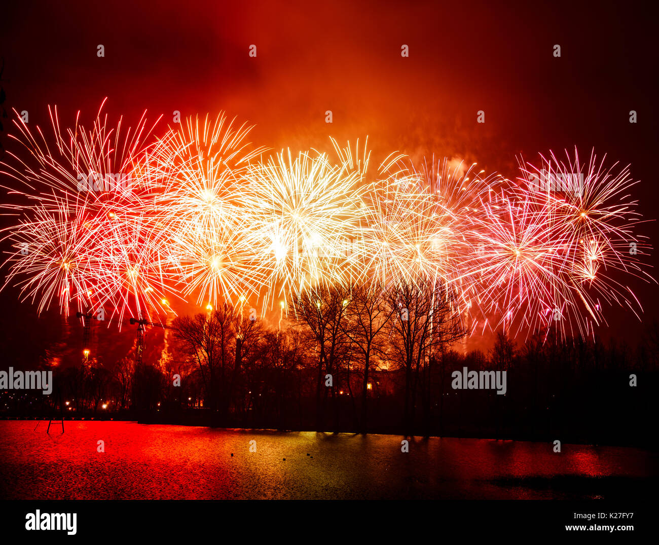 Beautiful, colorful fireworks above the river during an Independence ...