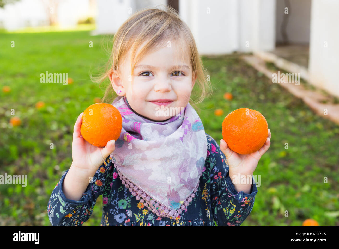 Happy laughing child playing with orange in a garden Stock Photo - Alamy