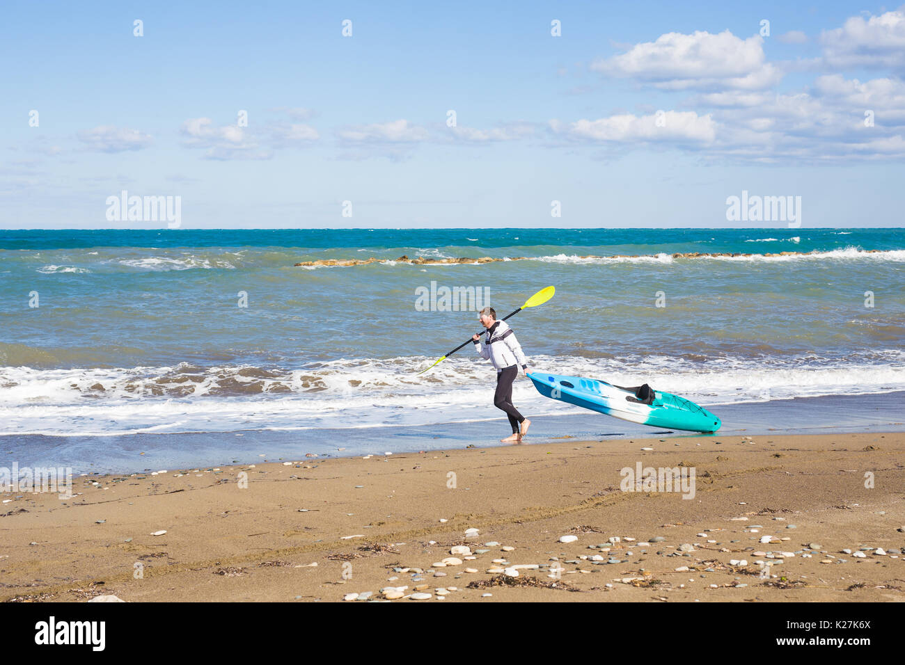 Man walking on the beach with kayak. Traveling by sea. Leisure ...