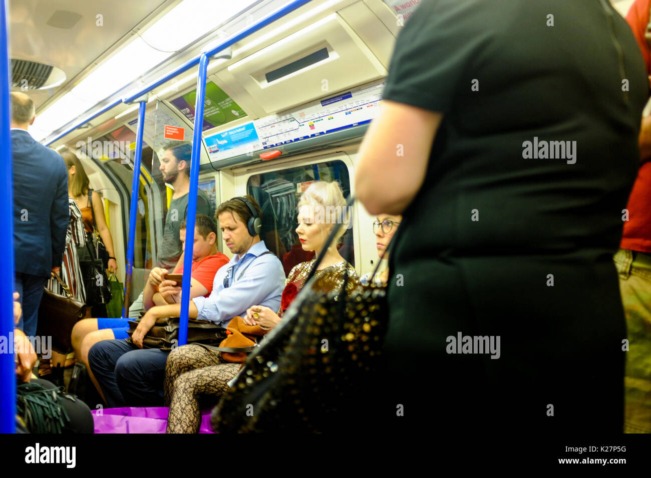 An elegant young woman rides the subway in London, England Septemer 20 ...