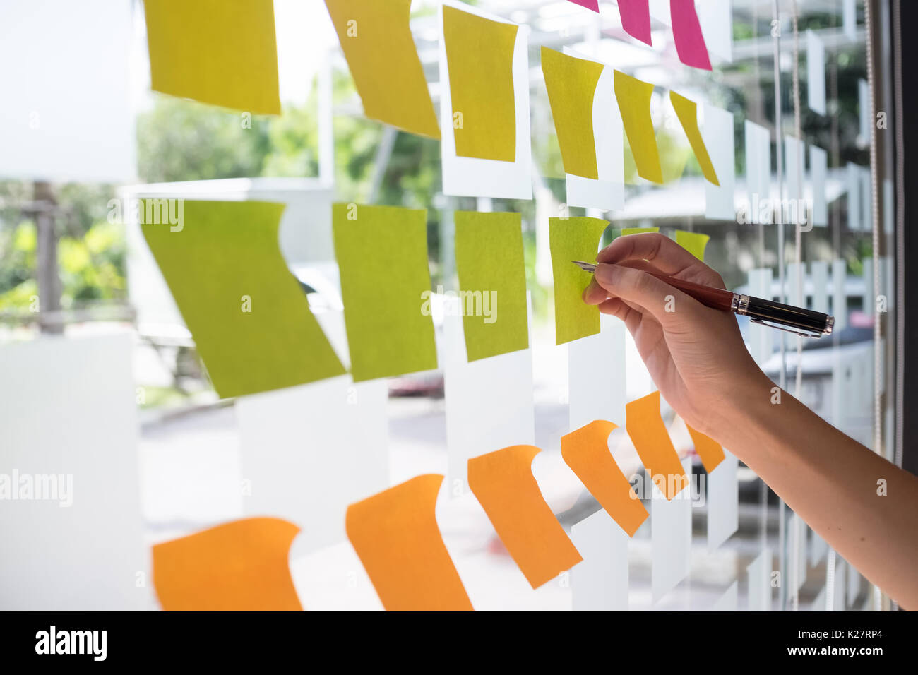 Hand using sticky notes hi-res stock photography and images - Alamy