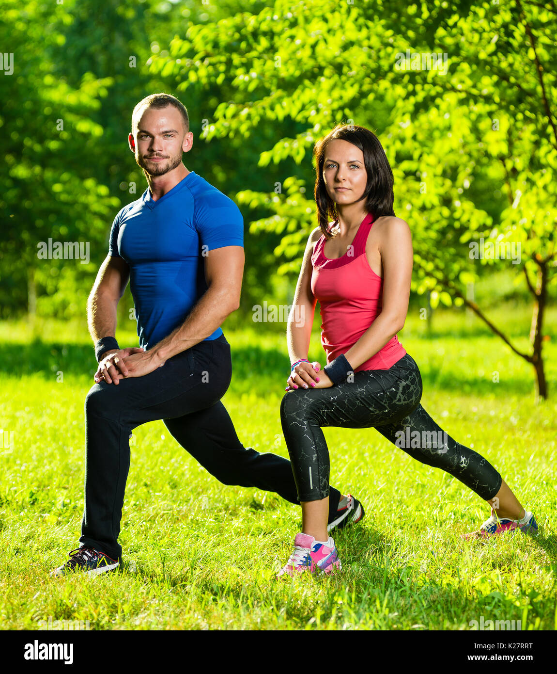 Man and woman doing stretching exercises Stock Photo - Alamy